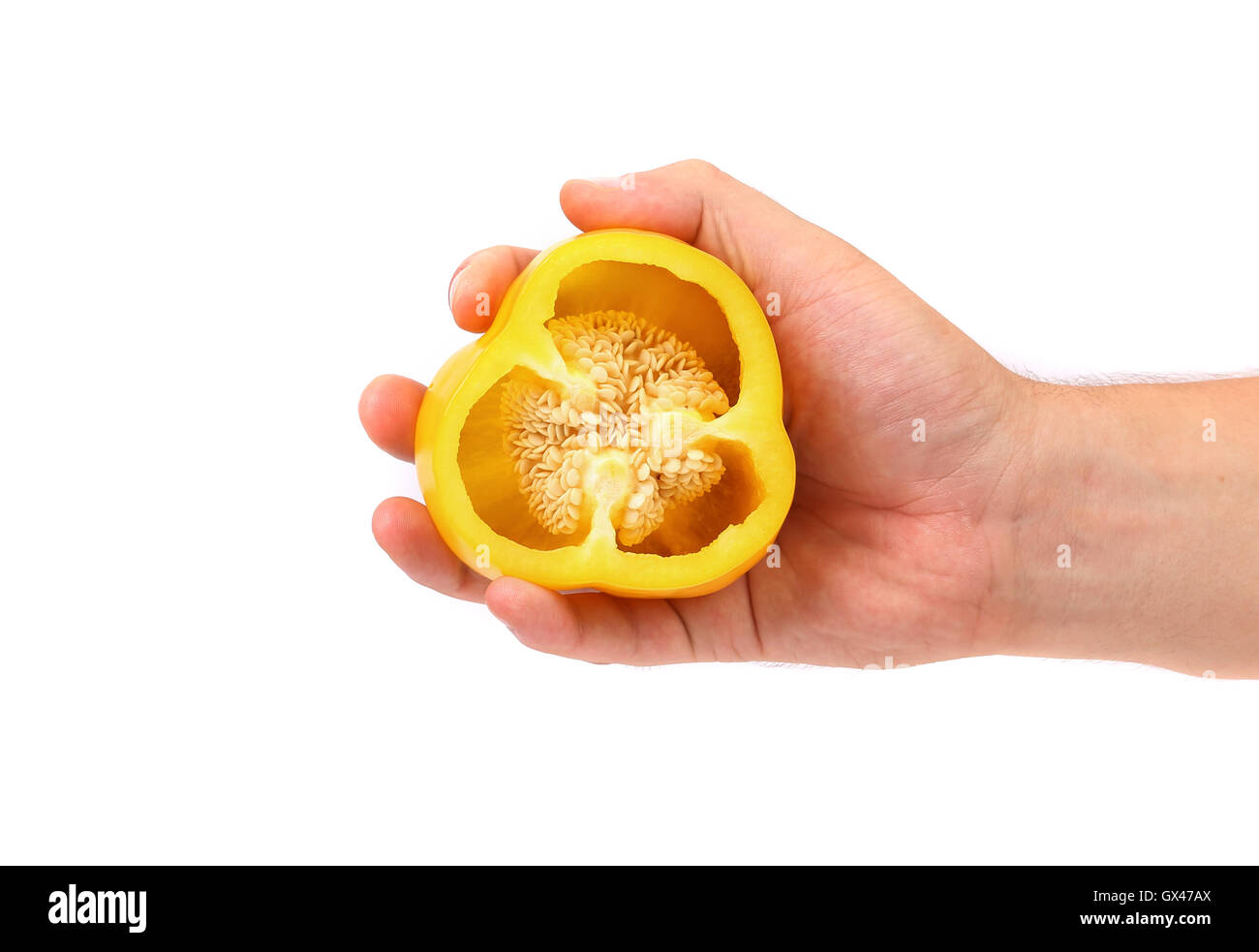 Hand holds half of yellow pepper Stock Photo - Alamy