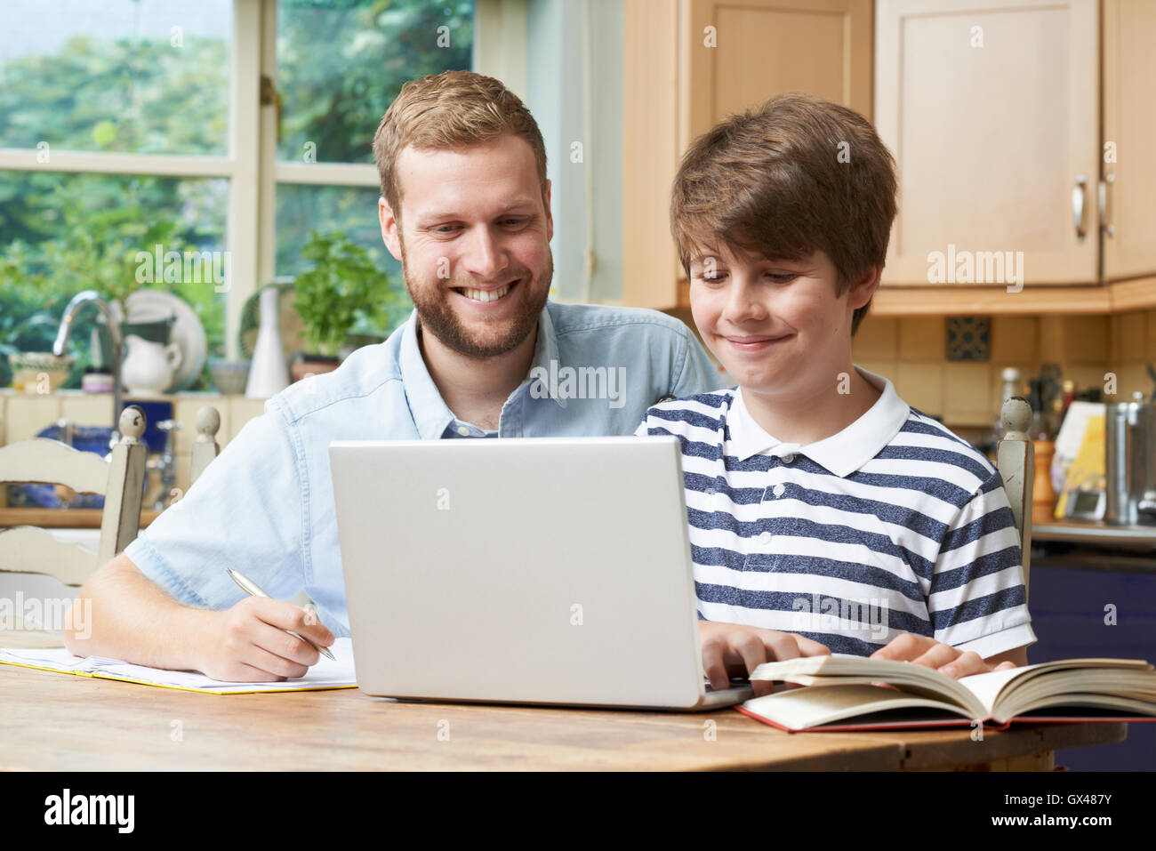 Male Home Tutor Helping Boy With Studies Stock Photo - Alamy