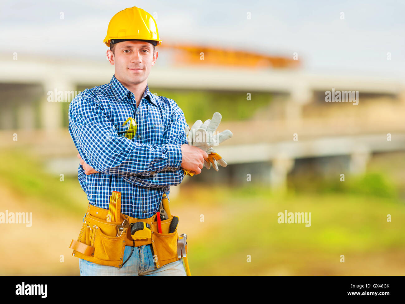 a young contractor with tools on construction site Stock Photo - Alamy