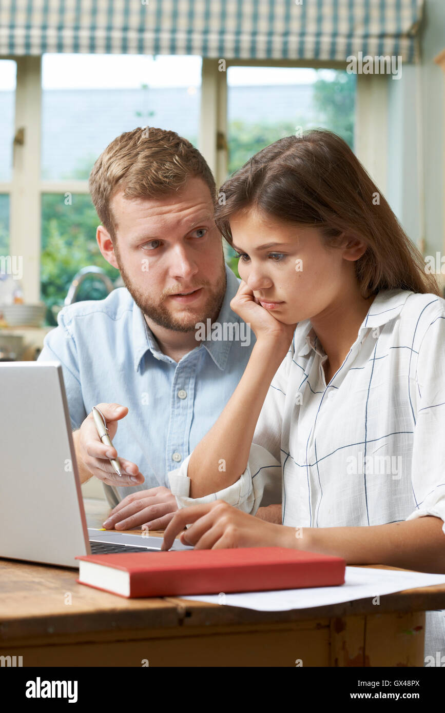 Male Home Tutor Helping Teenage Girl With Studies Stock Photo - Alamy