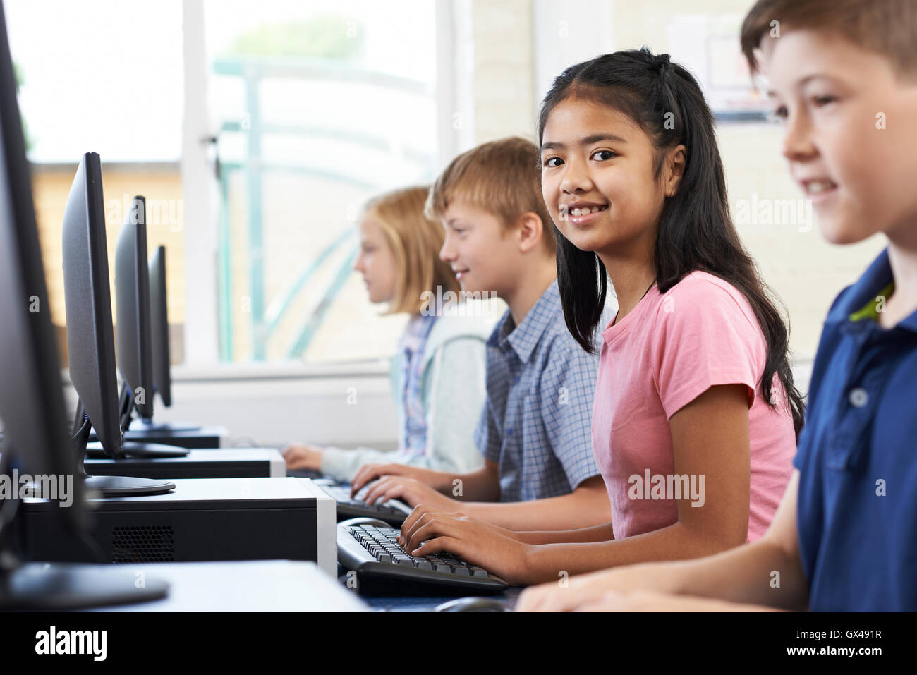 Female Elementary Pupil In Computer Class Stock Photo - Alamy