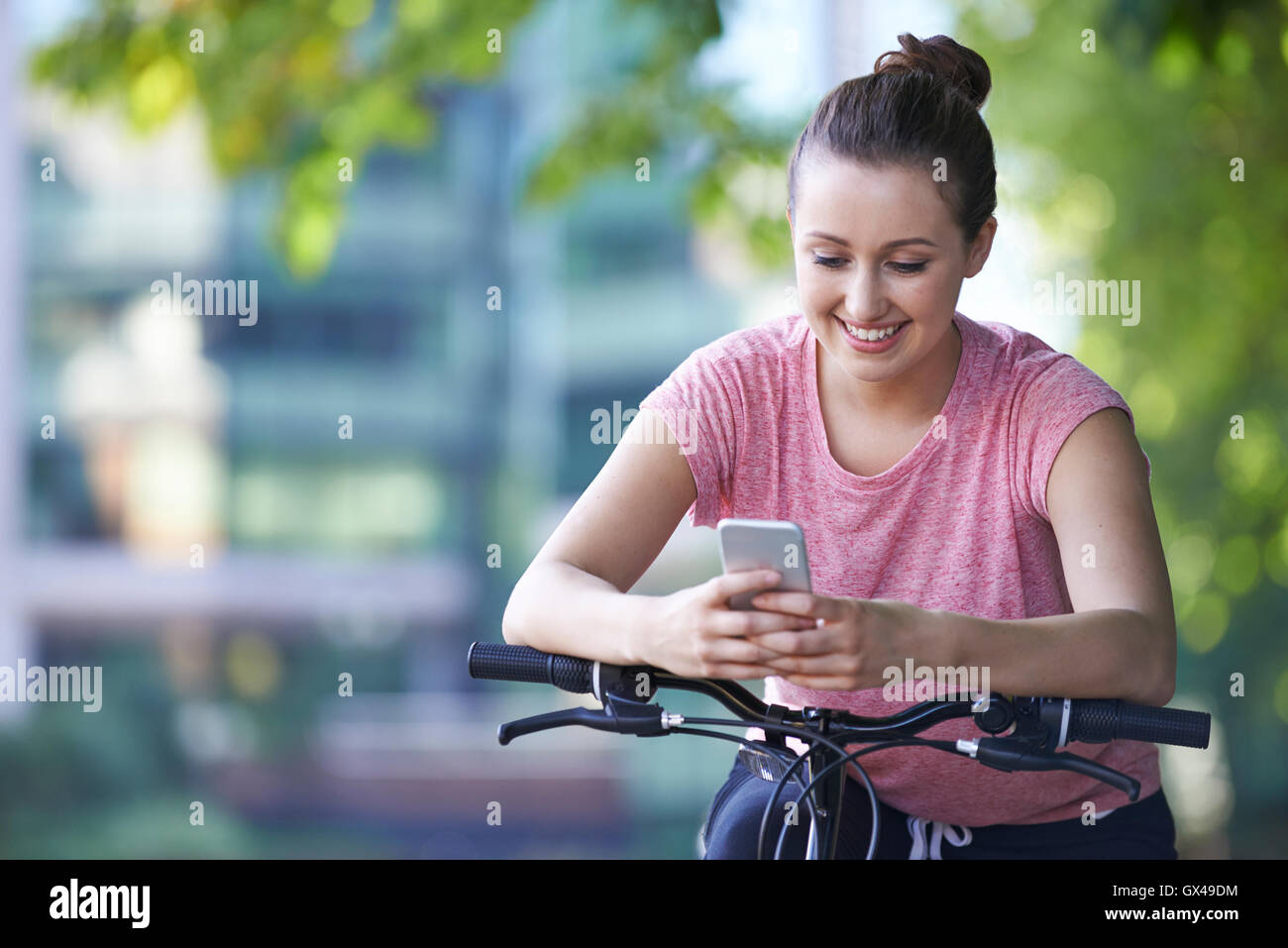 Woman using mobile phone whilst cycling hi-res stock photography and ...