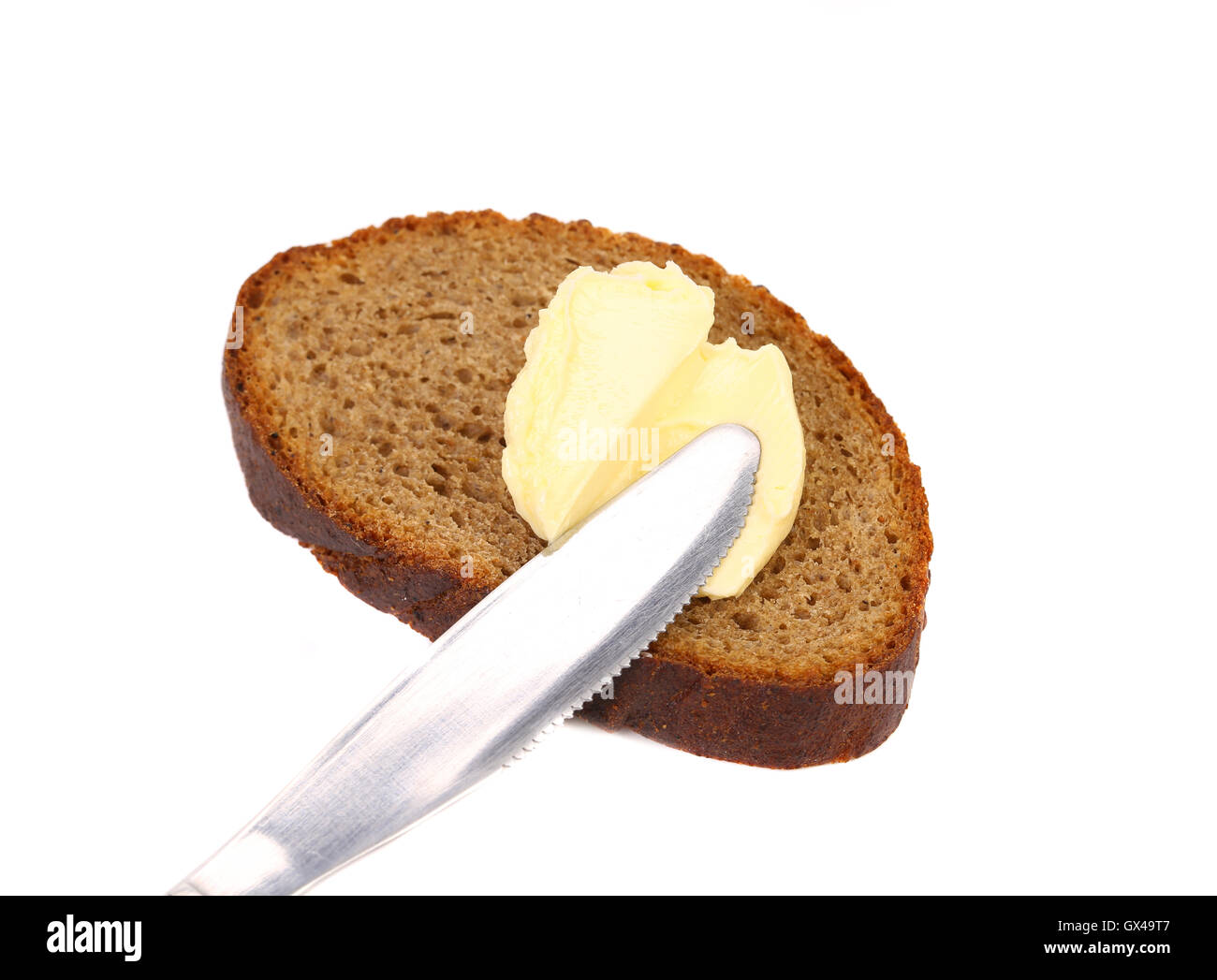 Buttering knife on brown bread Stock Photo - Alamy