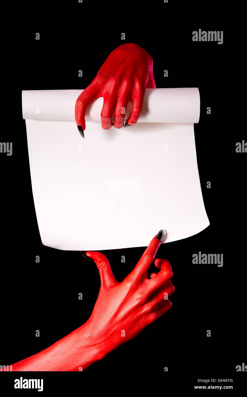 Red devil hands with paper scroll Stock Photo - Alamy