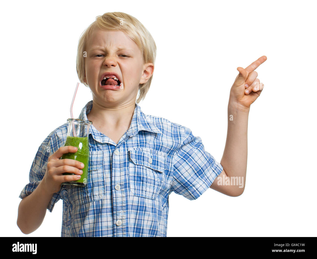 Disgusted boy with green smoothie pointing Stock Photo - Alamy