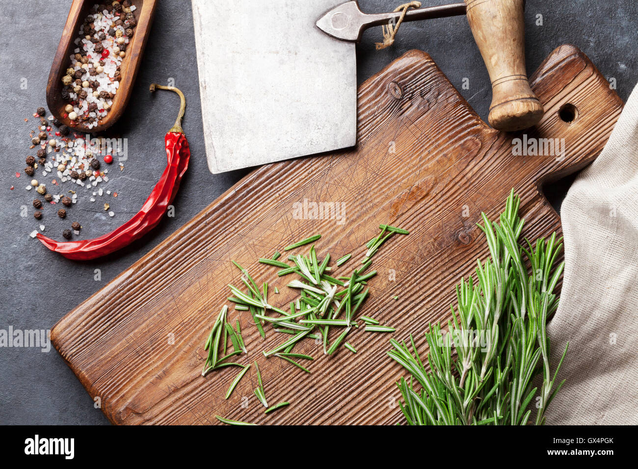Herbs and spices cooking on stone table. Rosemary, pepper and salt. Top ...