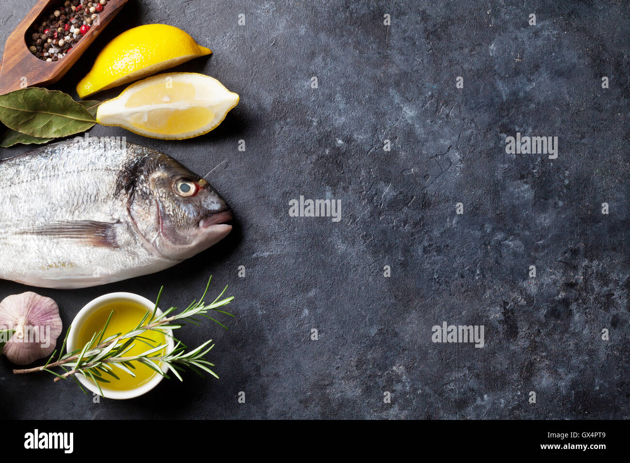 Raw fish cooking and ingredients. Dorado, lemon, herbs and spices. Top ...