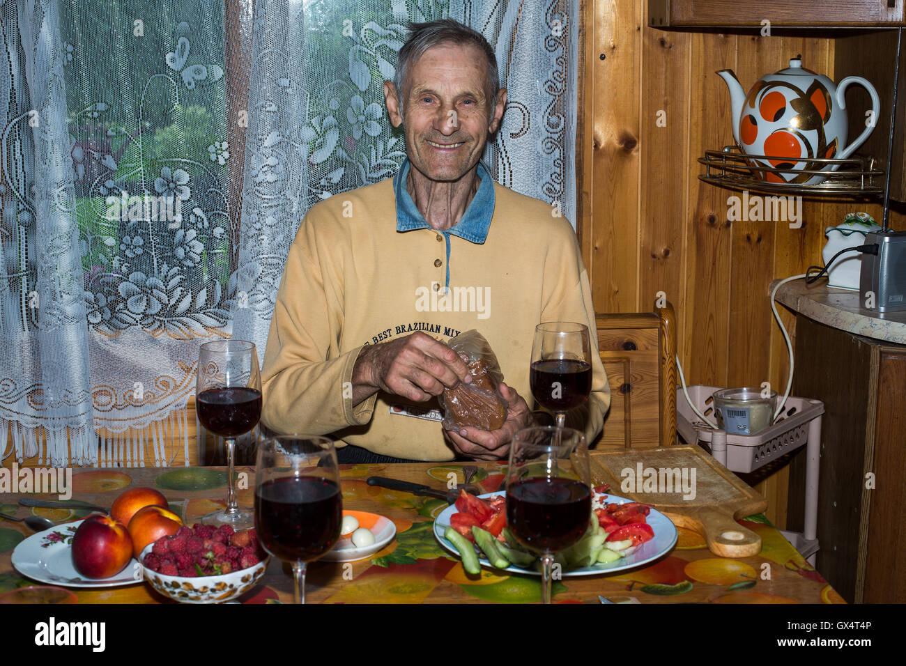 Portrait of senior man who is sitting at the dinner table Stock Photo ...