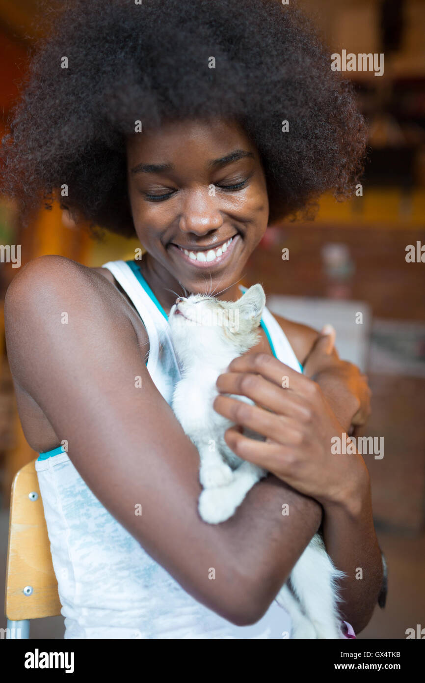 Beautiful afro american woman with a cat Stock Photo - Alamy