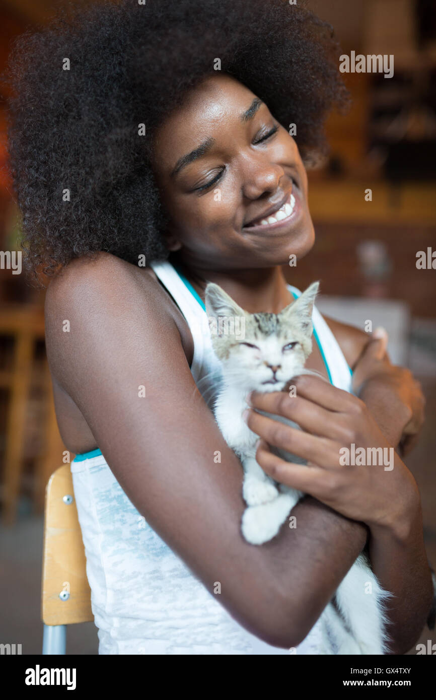 Beautiful afro american woman with a cat Stock Photo - Alamy