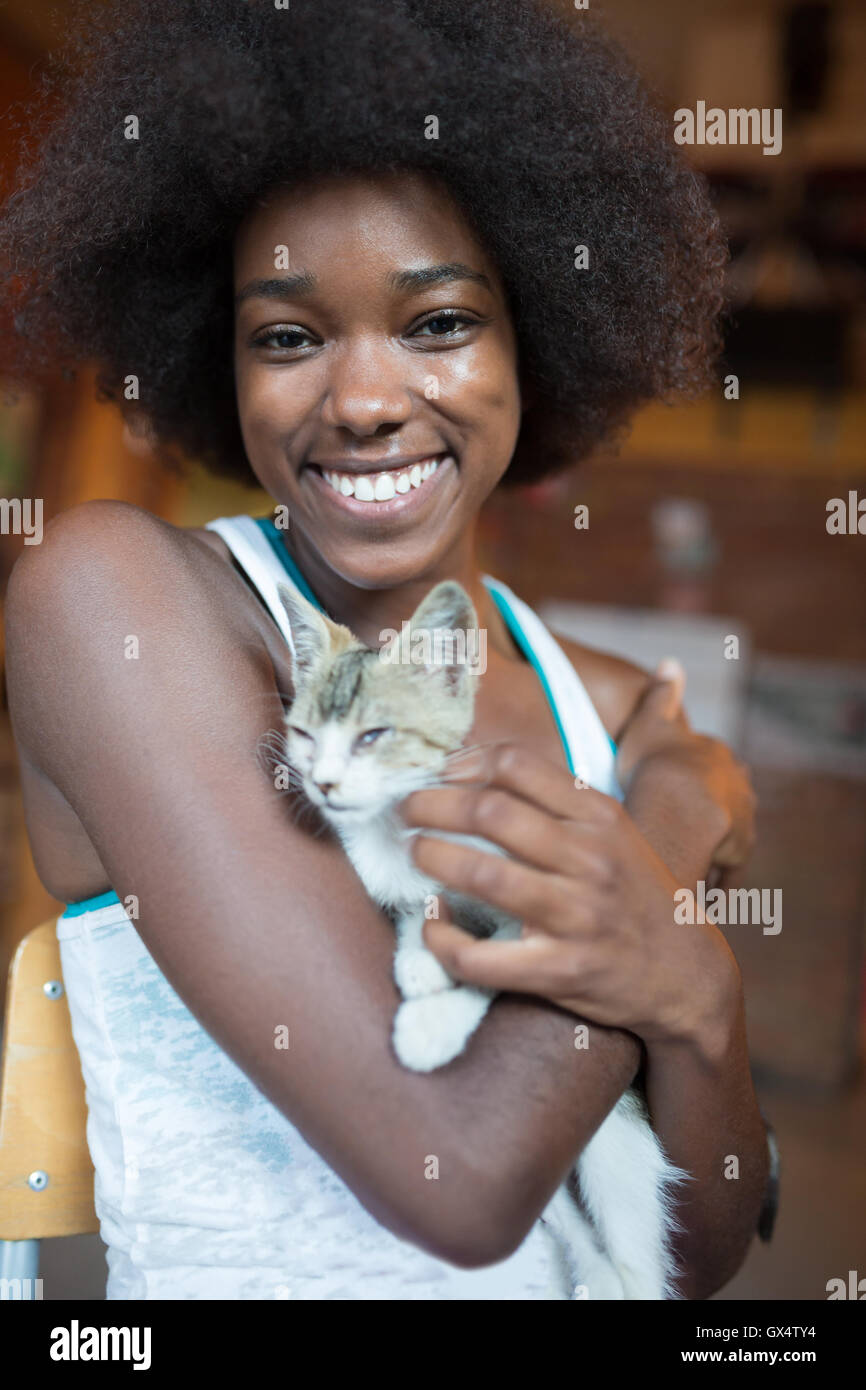 Beautiful afro american woman with a cat Stock Photo - Alamy
