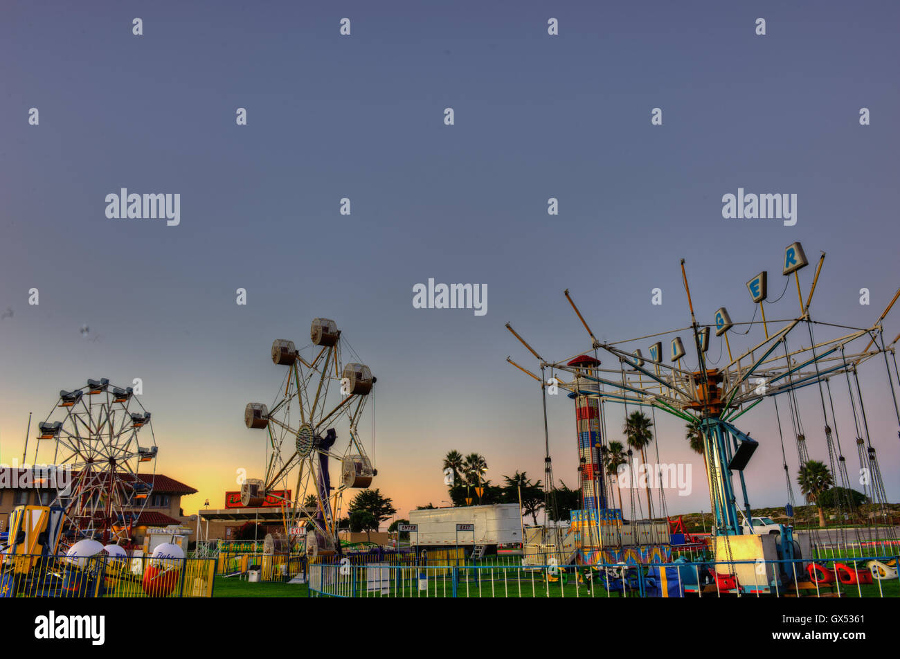 Sun rising behind small town carnival Stock Photo - Alamy