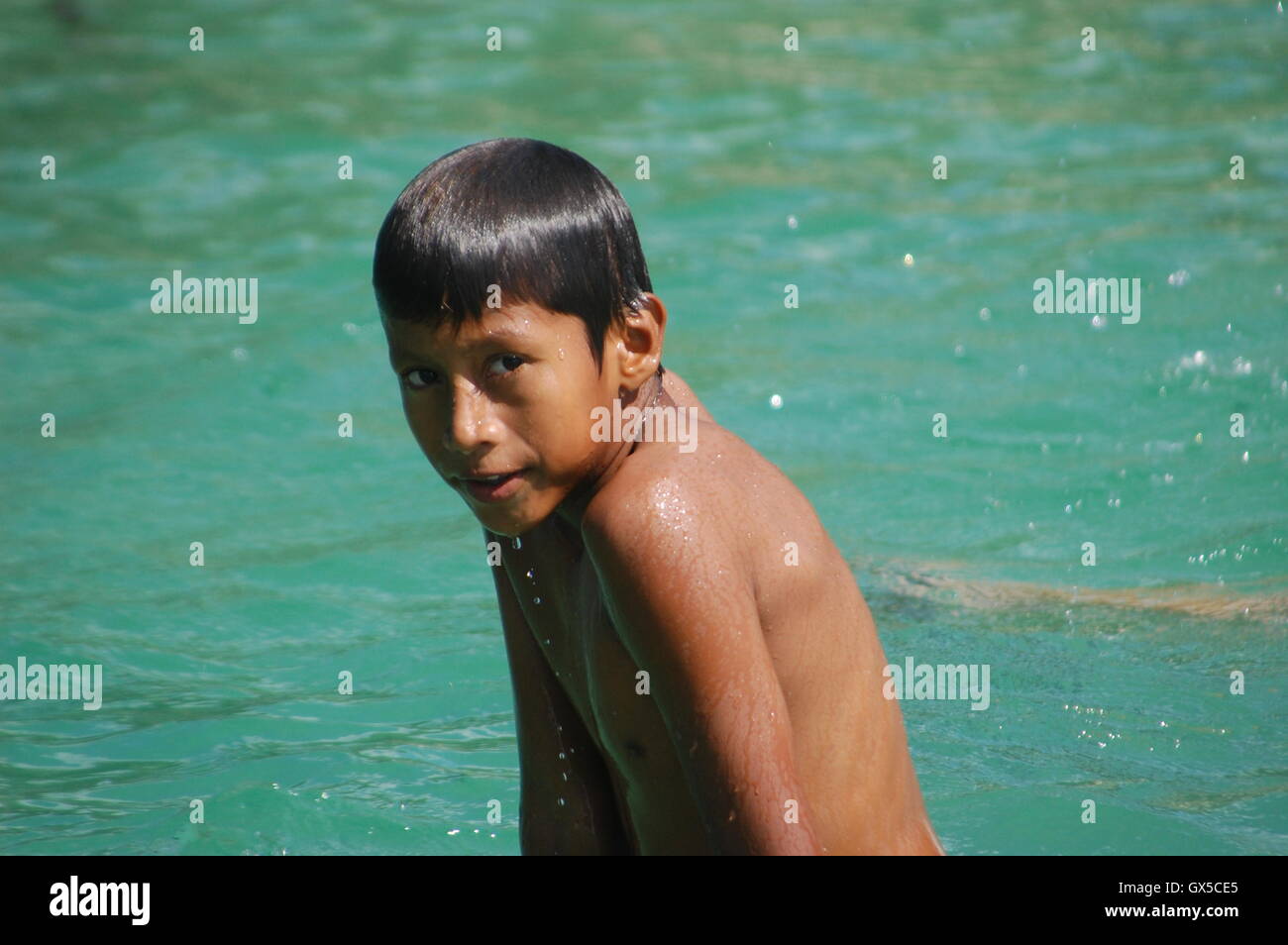 indigenous kid swimming in a lake, Peten Stock Photo - Alamy
