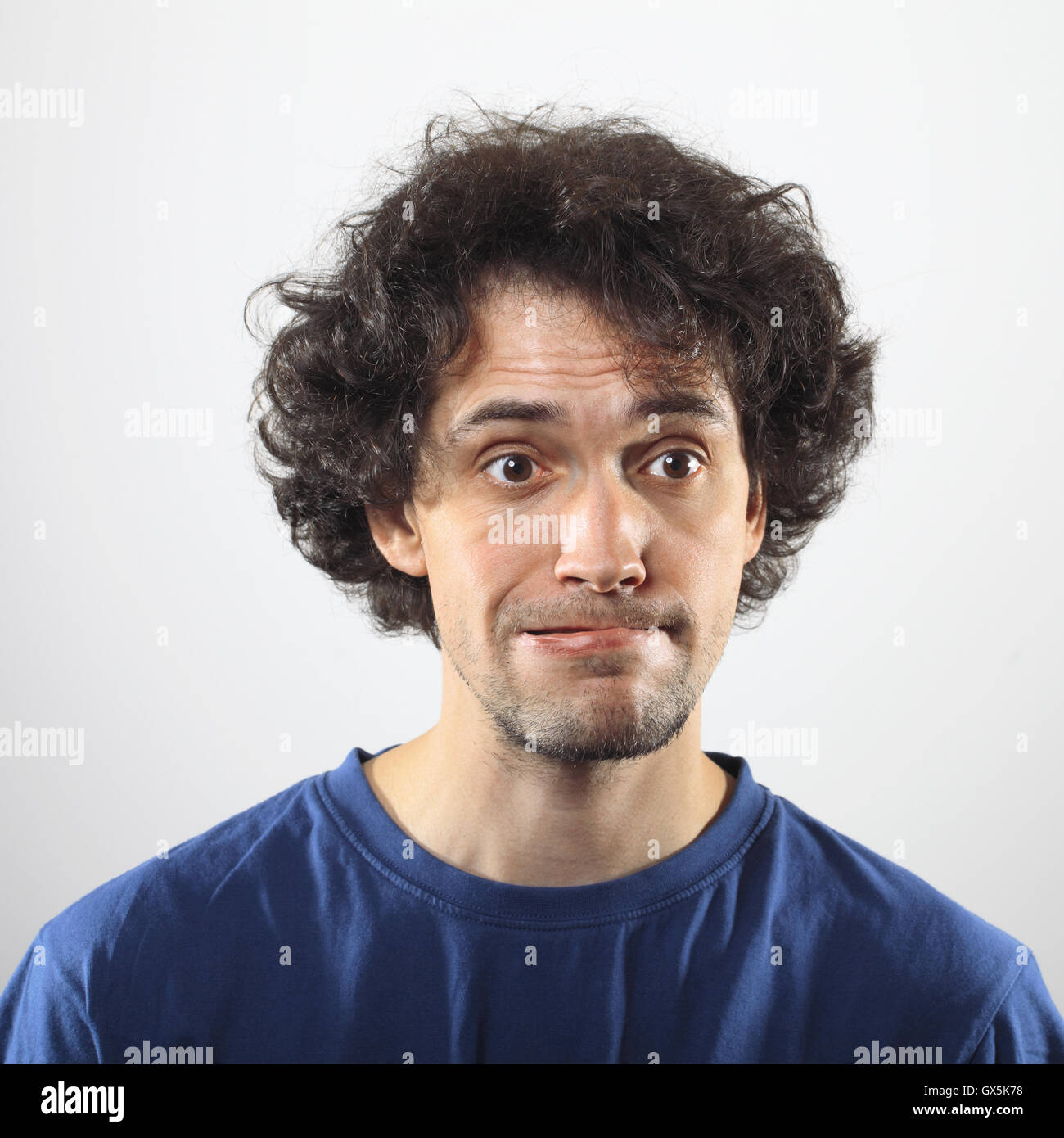 Surprised handsome young man in blue shirt Stock Photo - Alamy