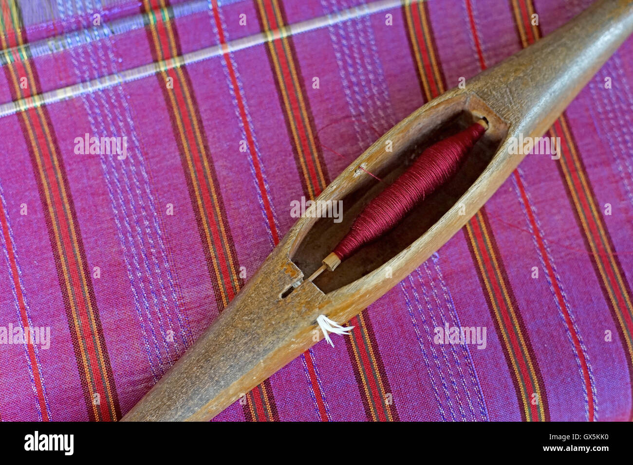 wooden bobbin on silk fabric, traditional weaving of Thai silk Stock ...