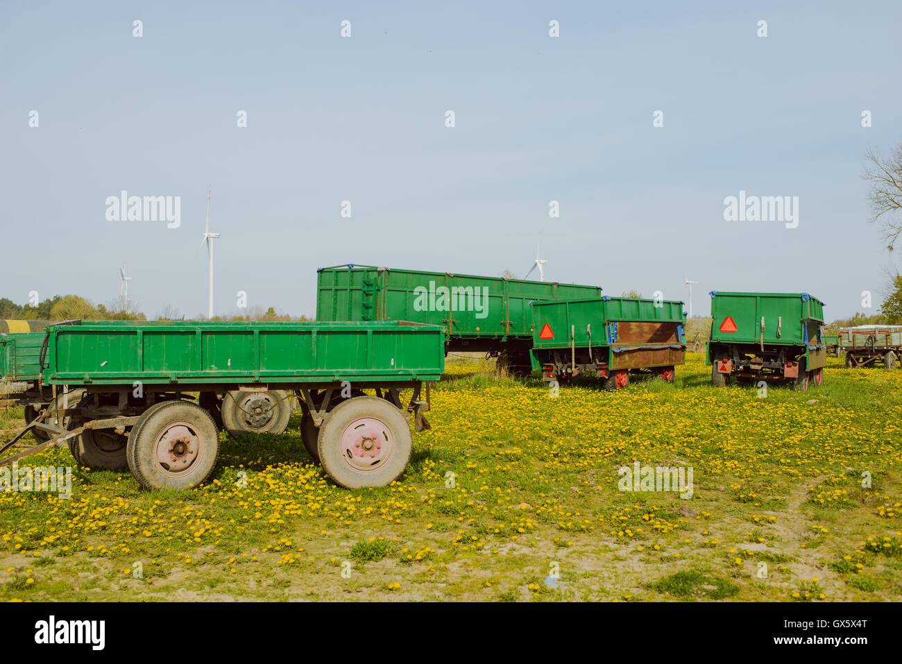 Green agricultural trailers on the farm in the morning Stock Photo - Alamy