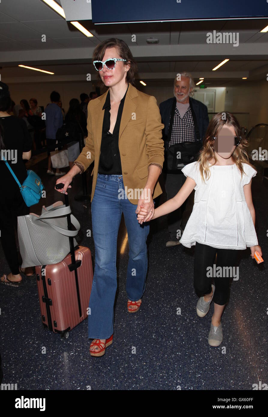 Milla Jovovich and her daughter Ever Gabo Anderson wearing sunglasses ...