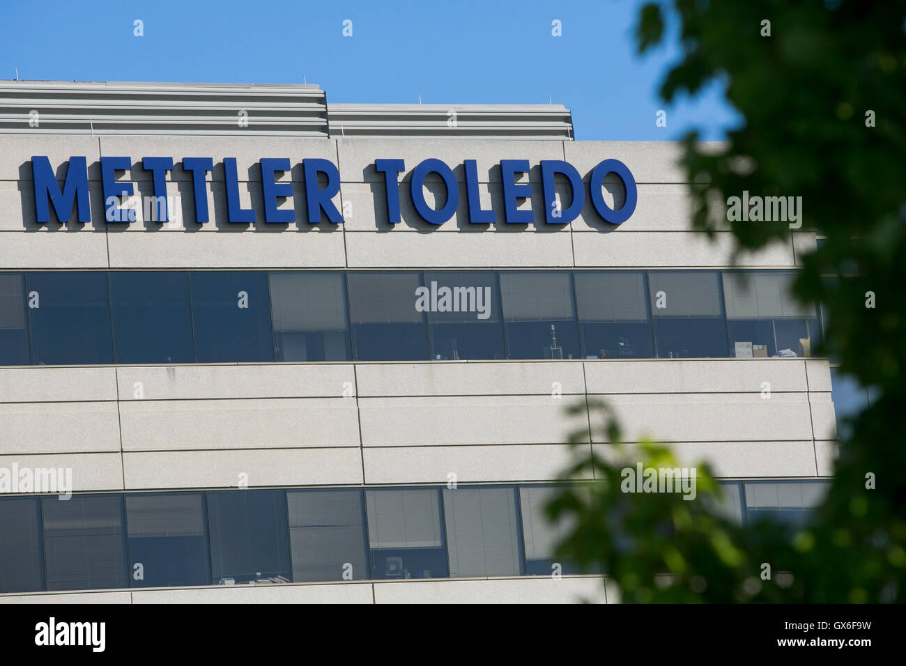 A logo sign outside of a facility occupied by Mettler-Toledo ...
