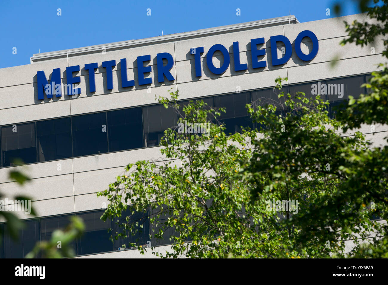 A logo sign outside of a facility occupied by Mettler-Toledo ...