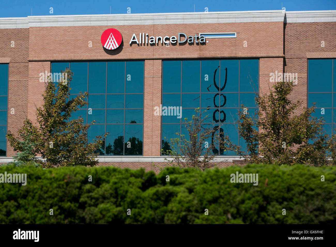 A logo sign outside of a facility occupied by the Alliance Data Systems ...