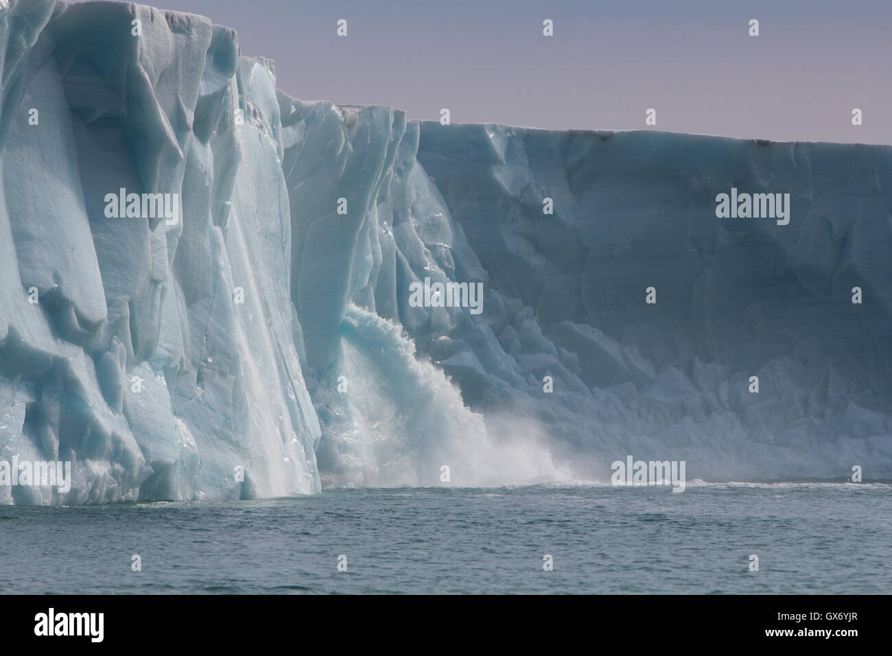 Waterfall pouring off the ice cliff at Nordaustlandet, Svalbard Stock ...