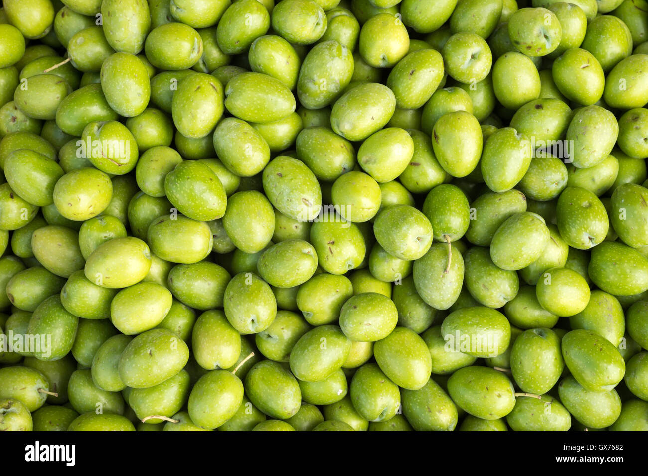 Many fresh green raw olives at the market Stock Photo - Alamy
