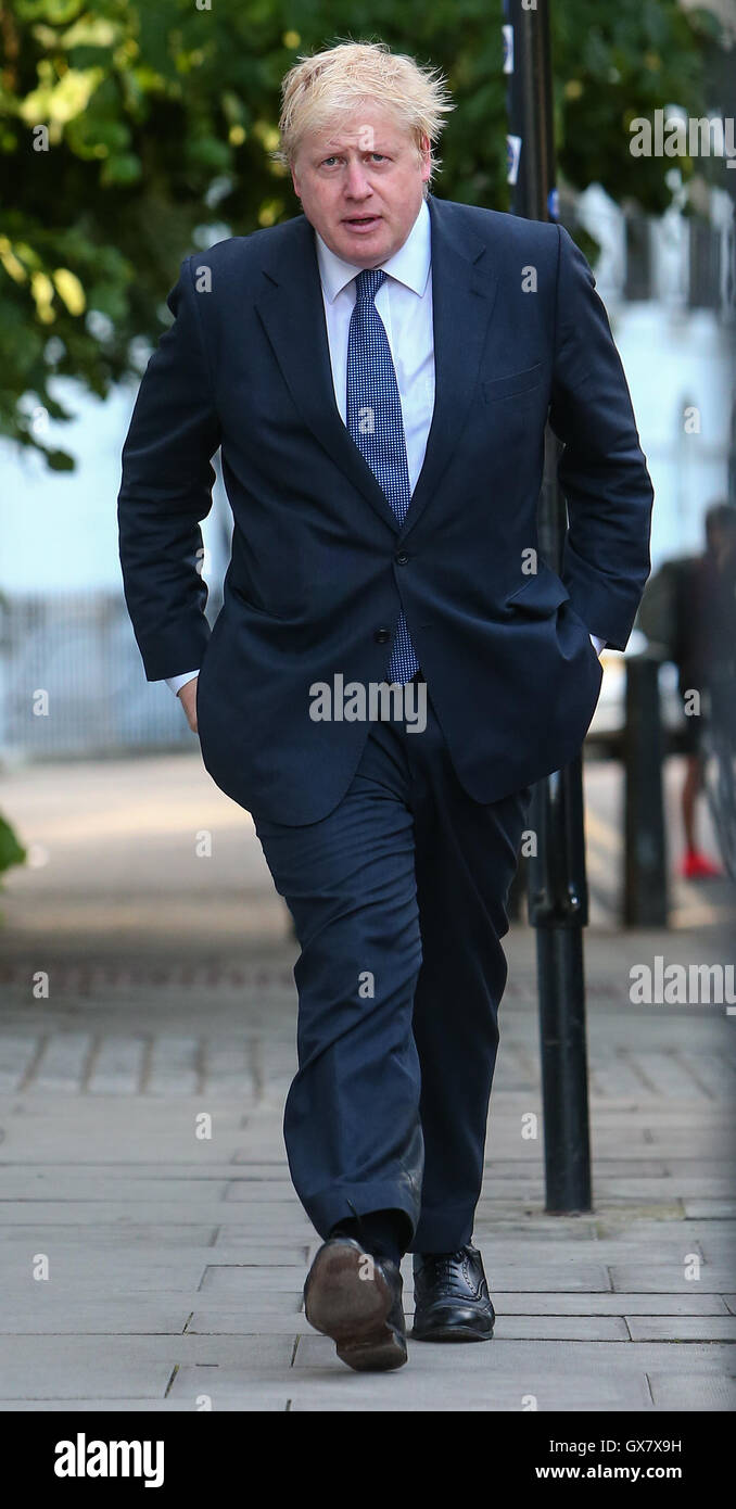 Boris Johnson MP leaves his north London home with a member of his team ...