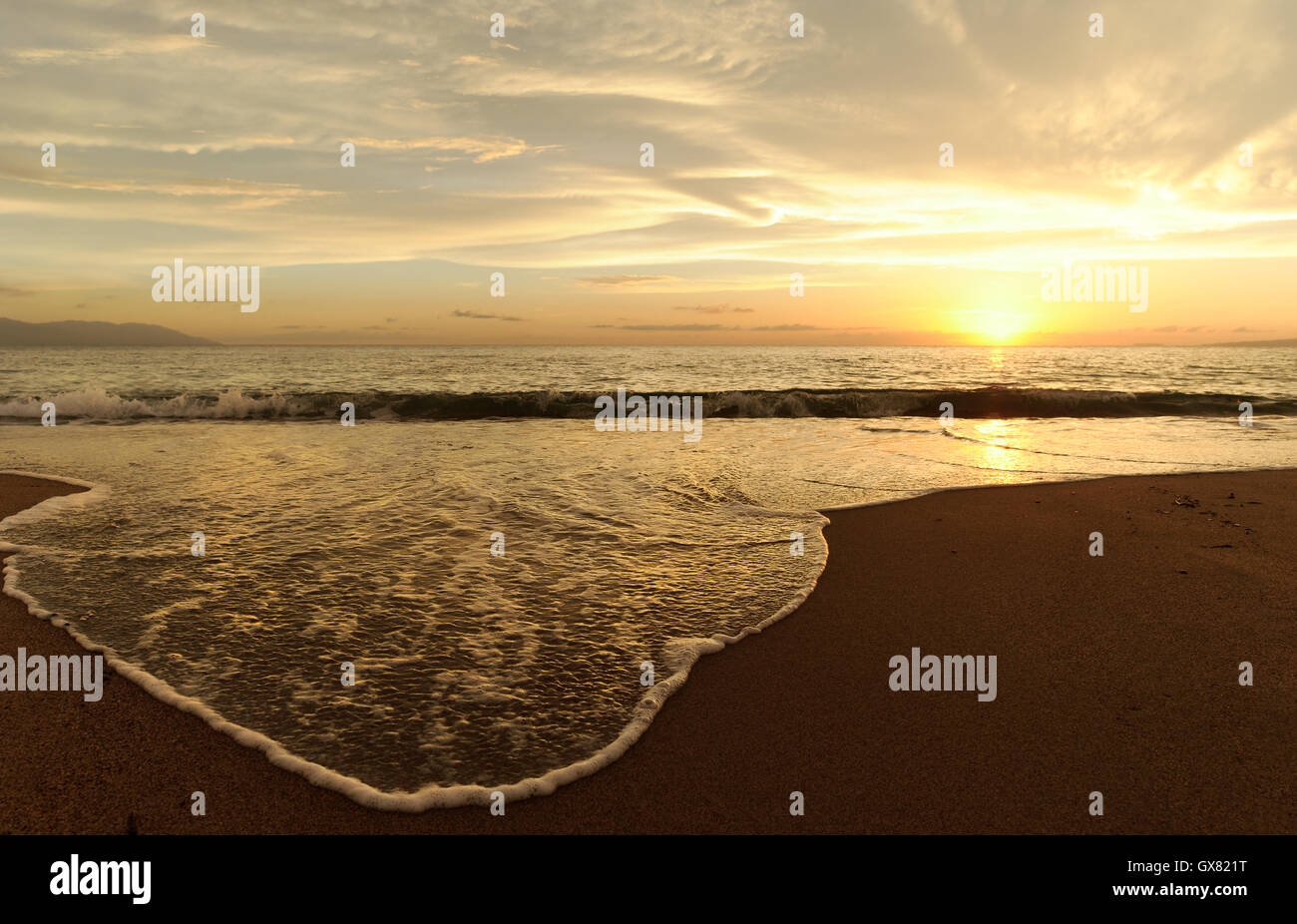 Sunset ocean is a bright sun setting on the ocean horizon as a gentle ...