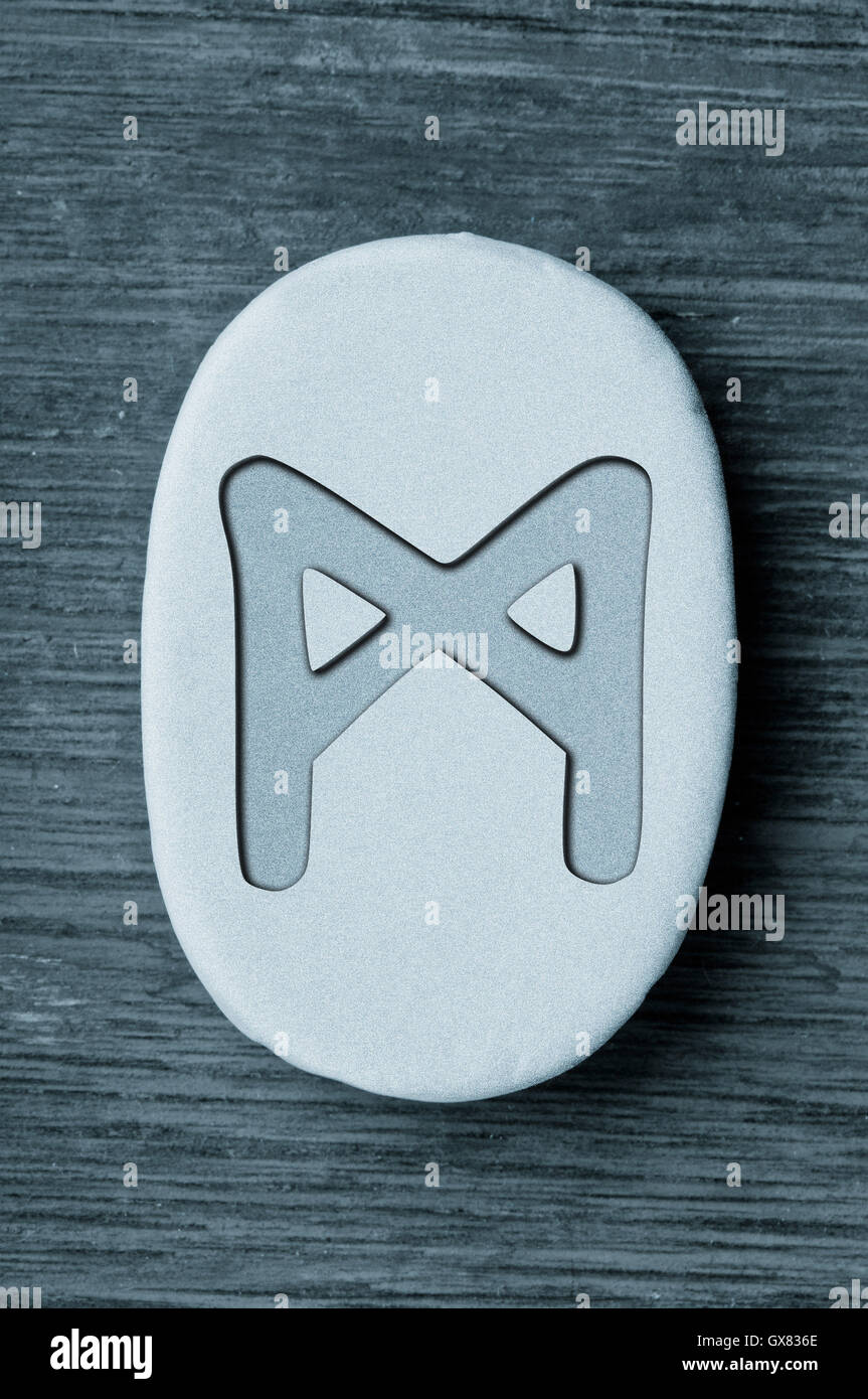 rune symbol Mannaz on stone Stock Photo - Alamy