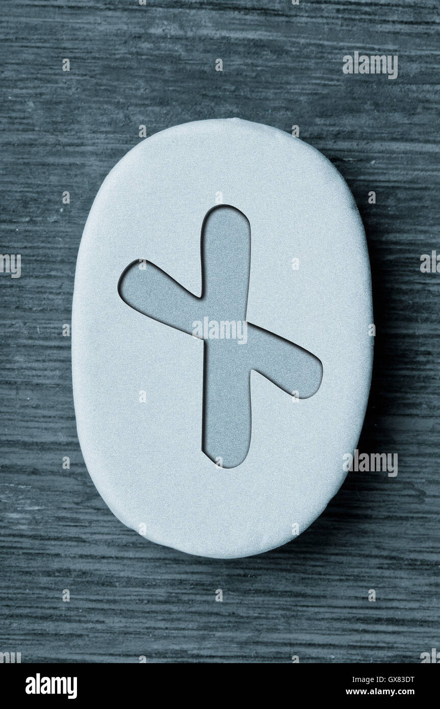 rune symbol Nauthiz on stone Stock Photo - Alamy