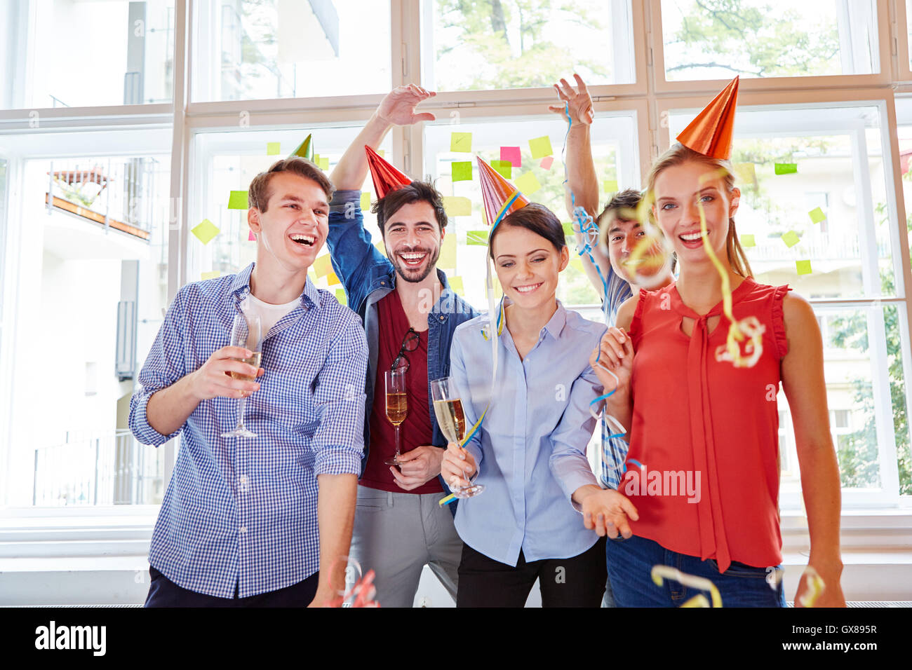 Successful team celebrating start-up's foundation with party as team ...