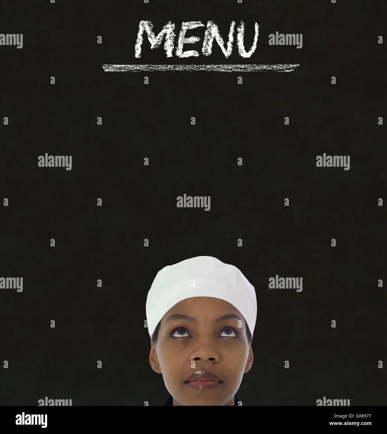 Chef with chalk menu sign on a blackboard background Stock Photo - Alamy