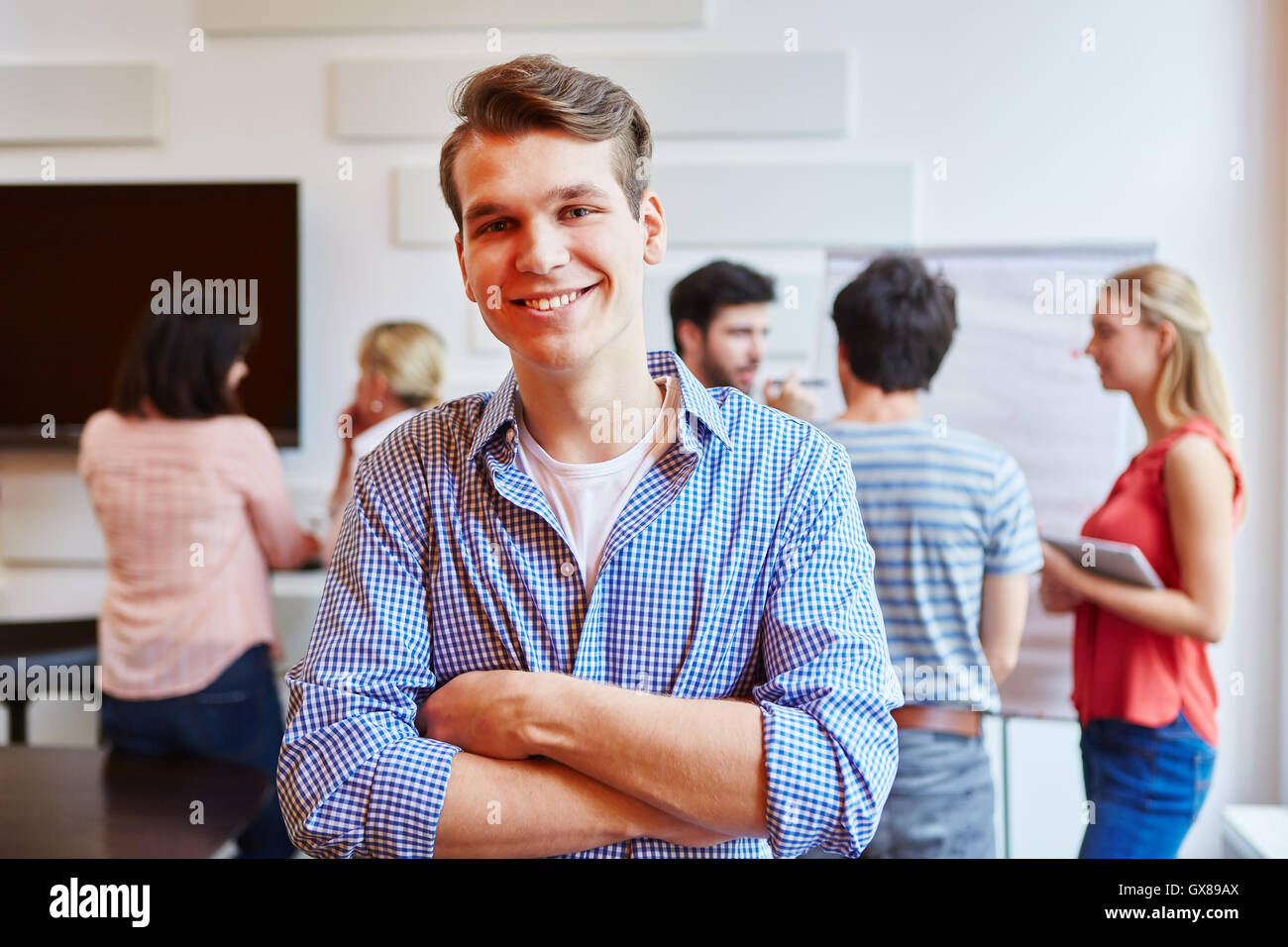 Smiling student arms crossed hi-res stock photography and images - Alamy