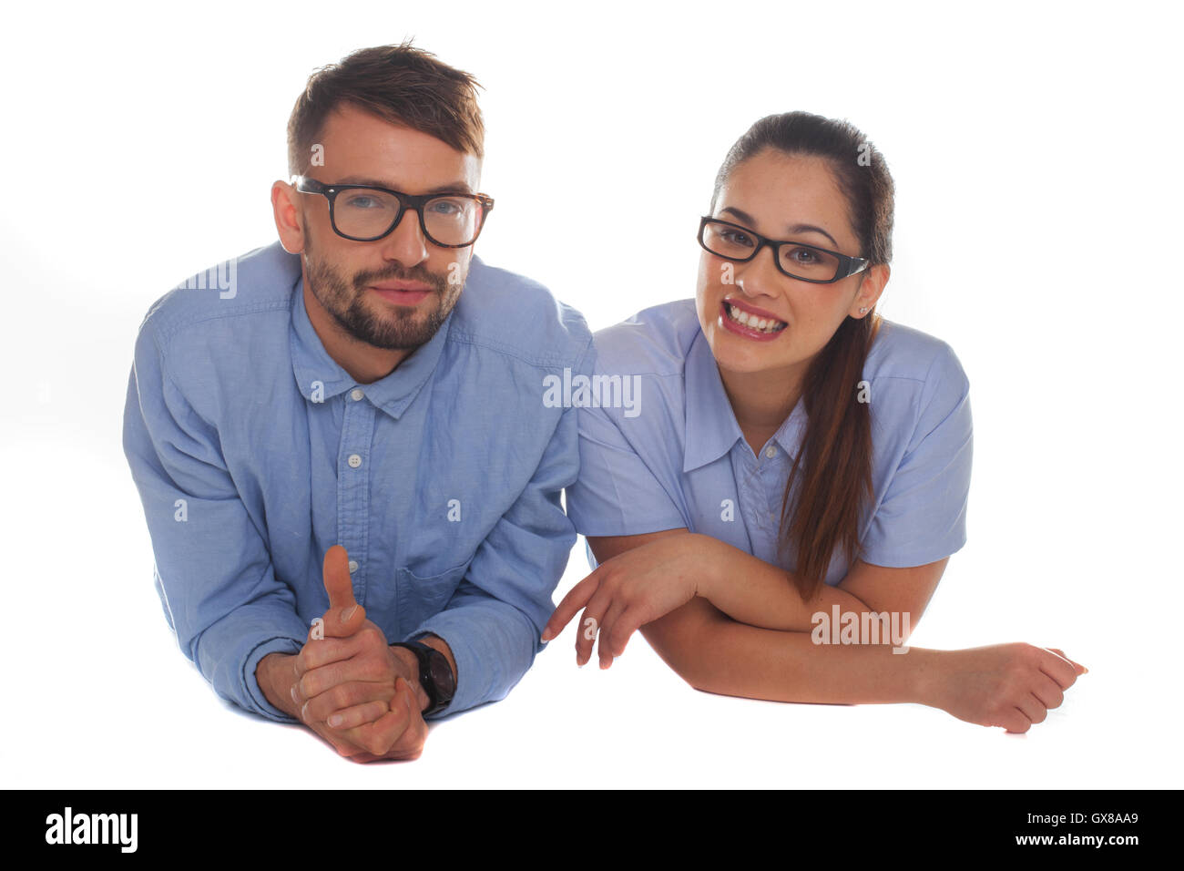 Nerdy looking couple looking at camera Stock Photo - Alamy