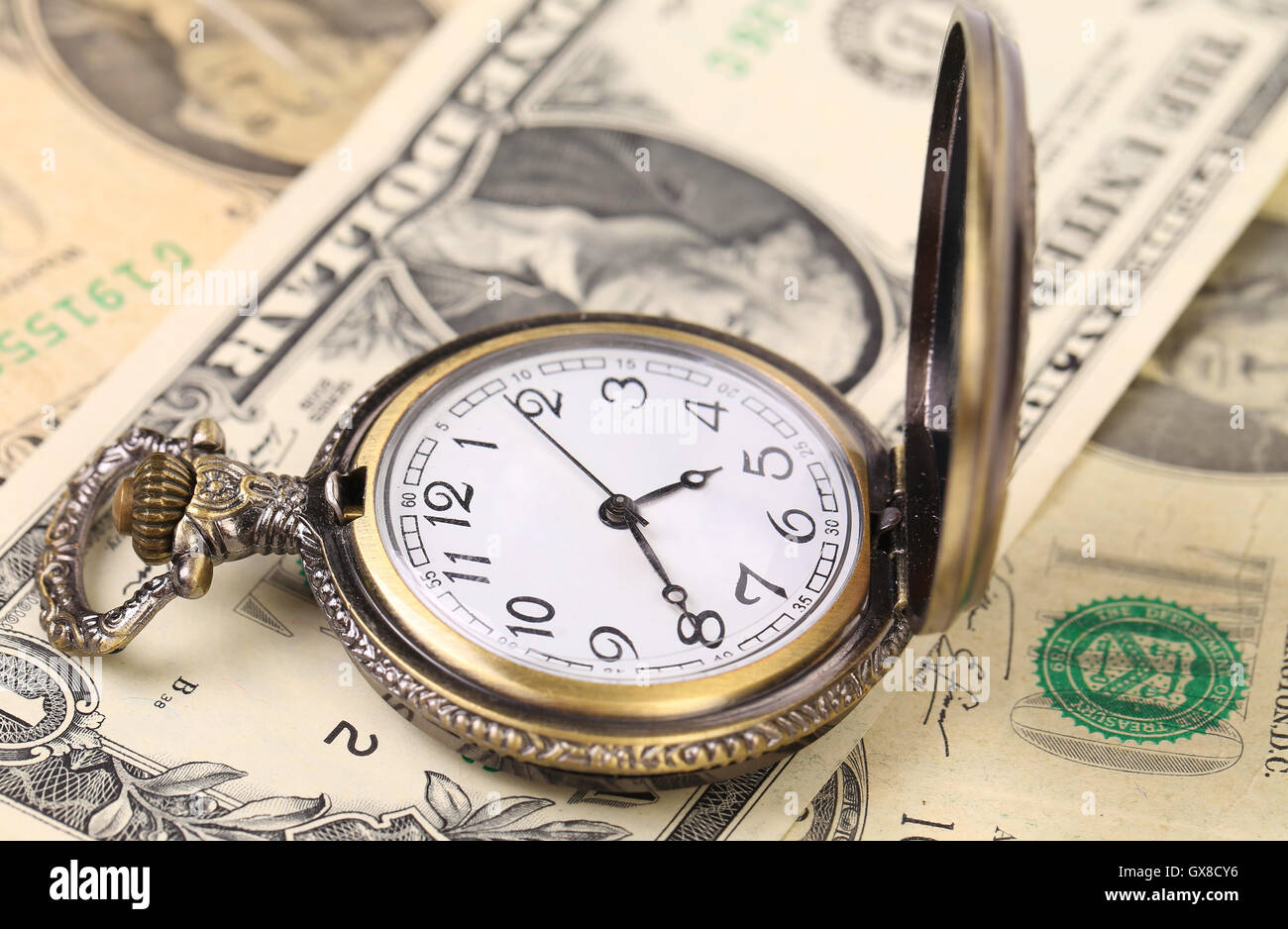 Vintage watch and dollars Stock Photo - Alamy