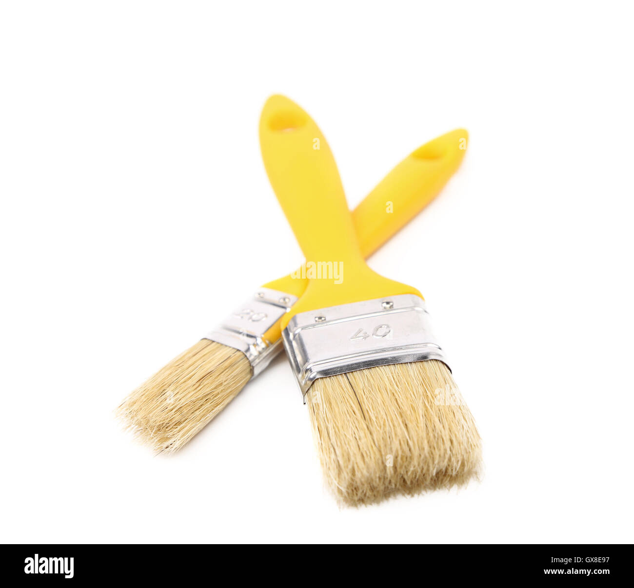Paint yellow brushes isolated on white Stock Photo - Alamy