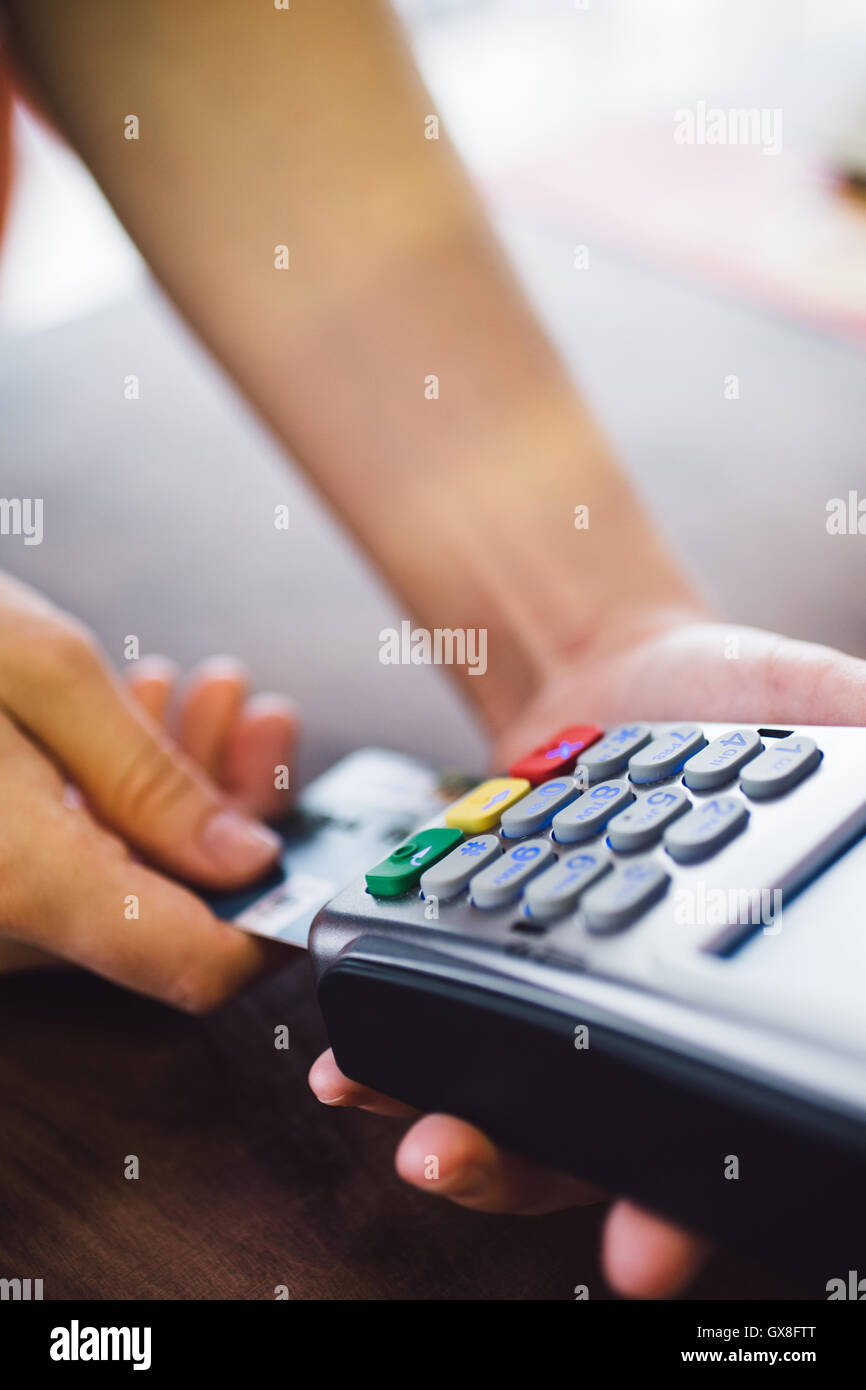 Female hand inserts the credit card into the terminal Stock Photo - Alamy