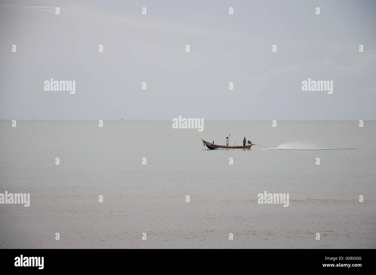 Fishing boat floating on the sea in morning and sunrise time at Sakom ...