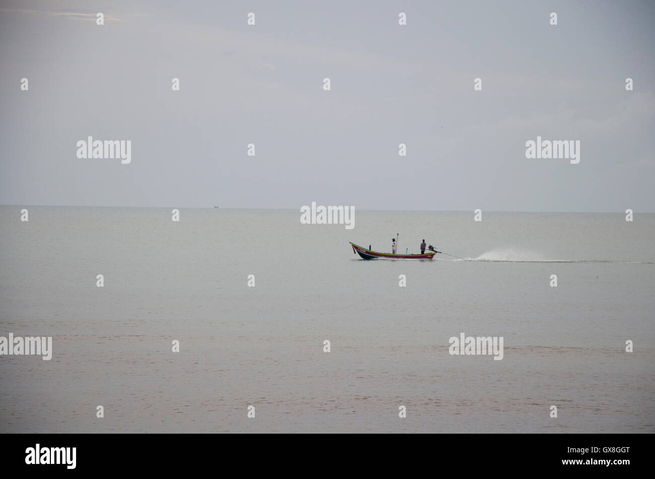 Fishing boat floating on the sea in morning and sunrise time at Sakom ...