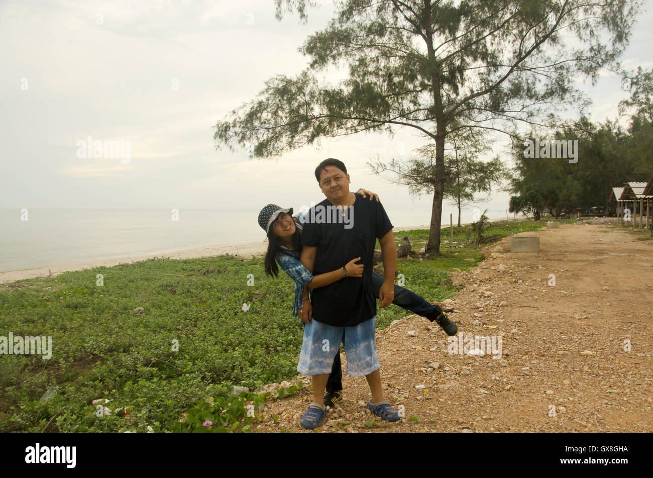 Lovers thai man and woman portrait at the sea in morning and sunrise ...