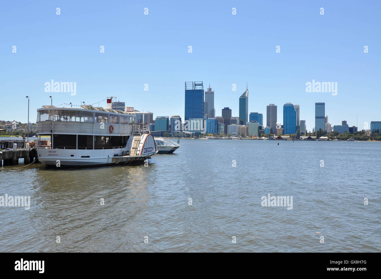 View of Perth Cityscape with river cruise boat docked on the Swan River ...