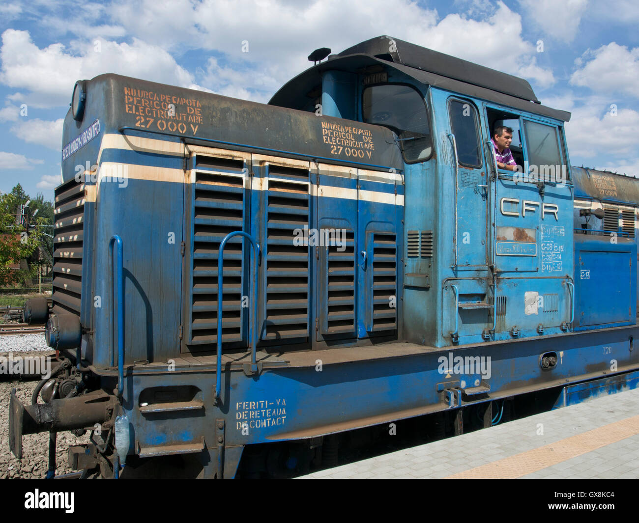 Old locomotive in a run down train station under renovation with ...