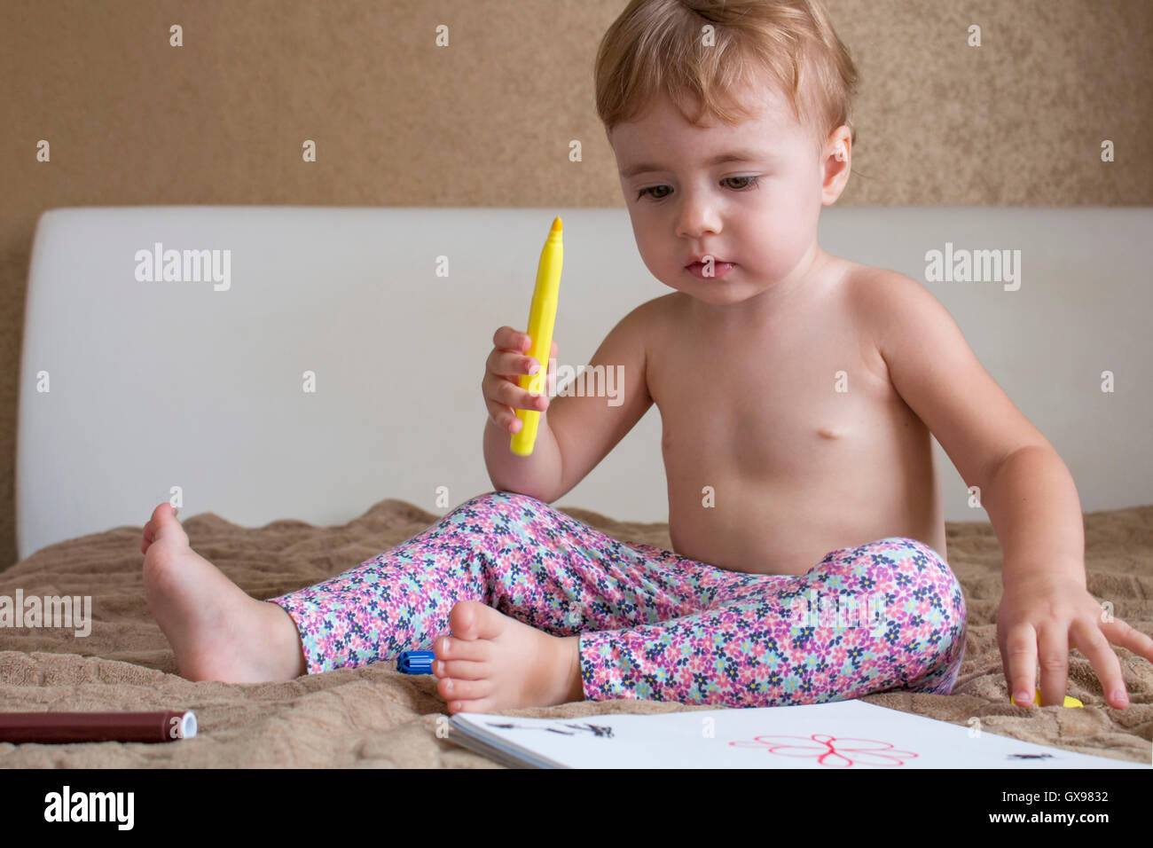 Portrait of lovely baby drawing with colorful pencils Stock Photo - Alamy