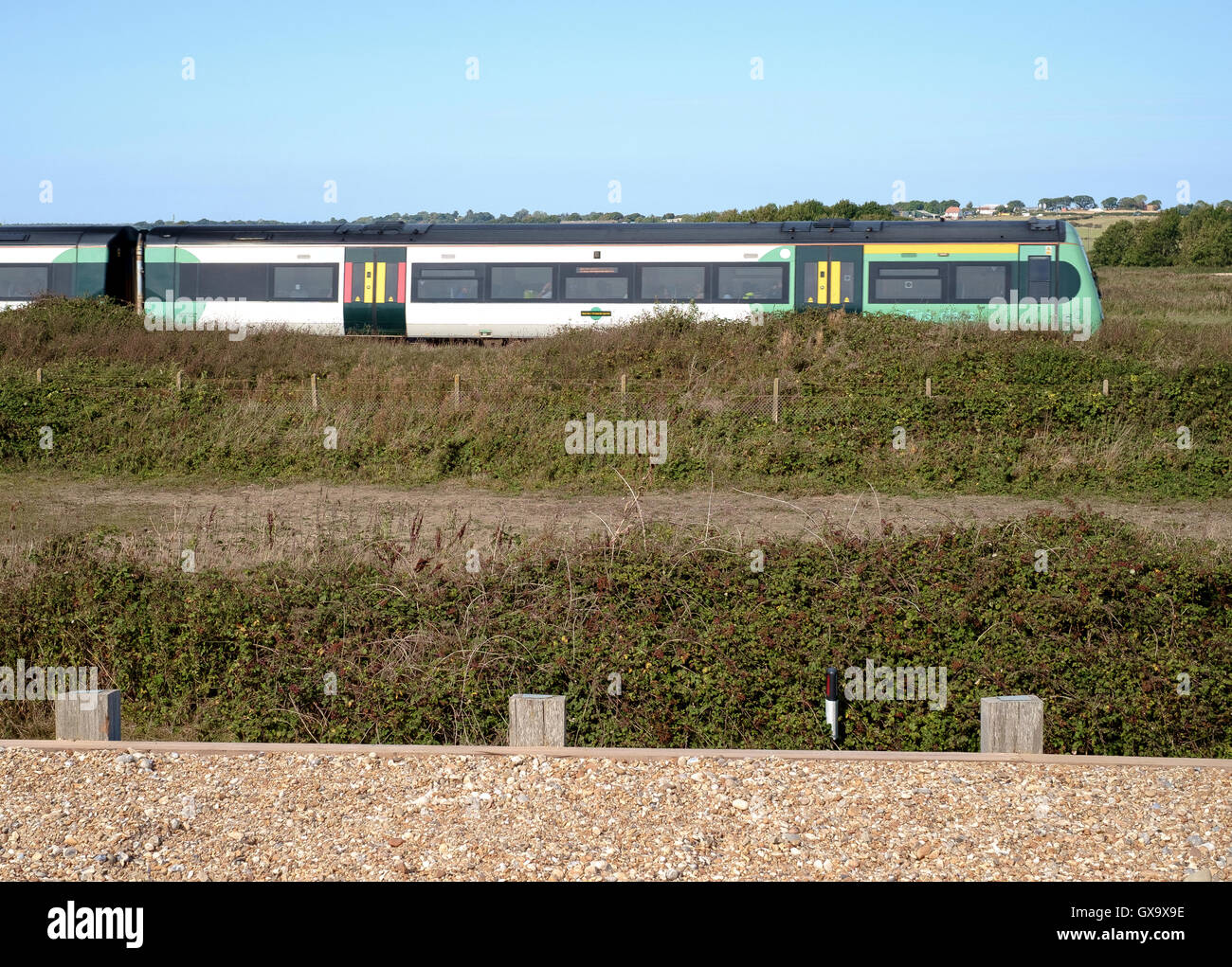 A Southern Rail train on the Coastway East line alongside the beach at ...