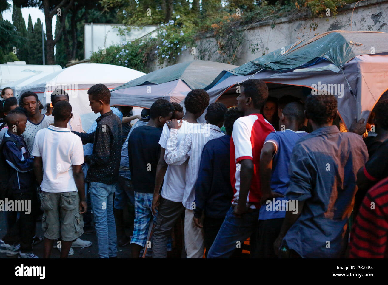 Rome, Italy. 14th Sep, 2016. Refugees queue at the food distribution ...