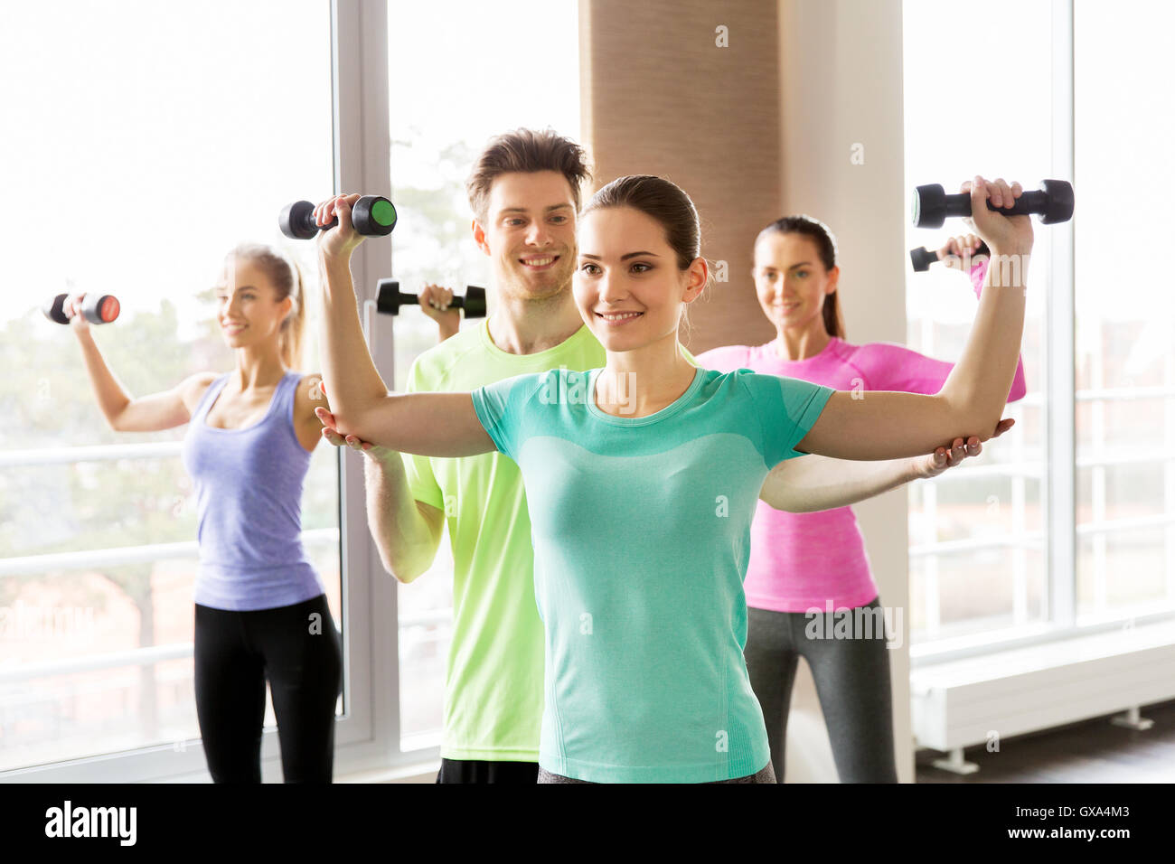 group of smiling people exercising with dumbbells Stock Photo - Alamy