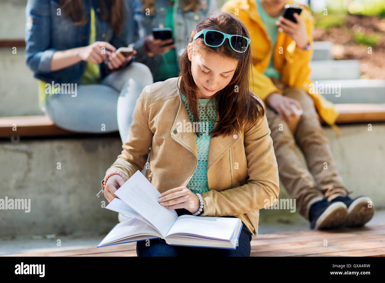 high school student girl reading book outdoors Stock Photo - Alamy