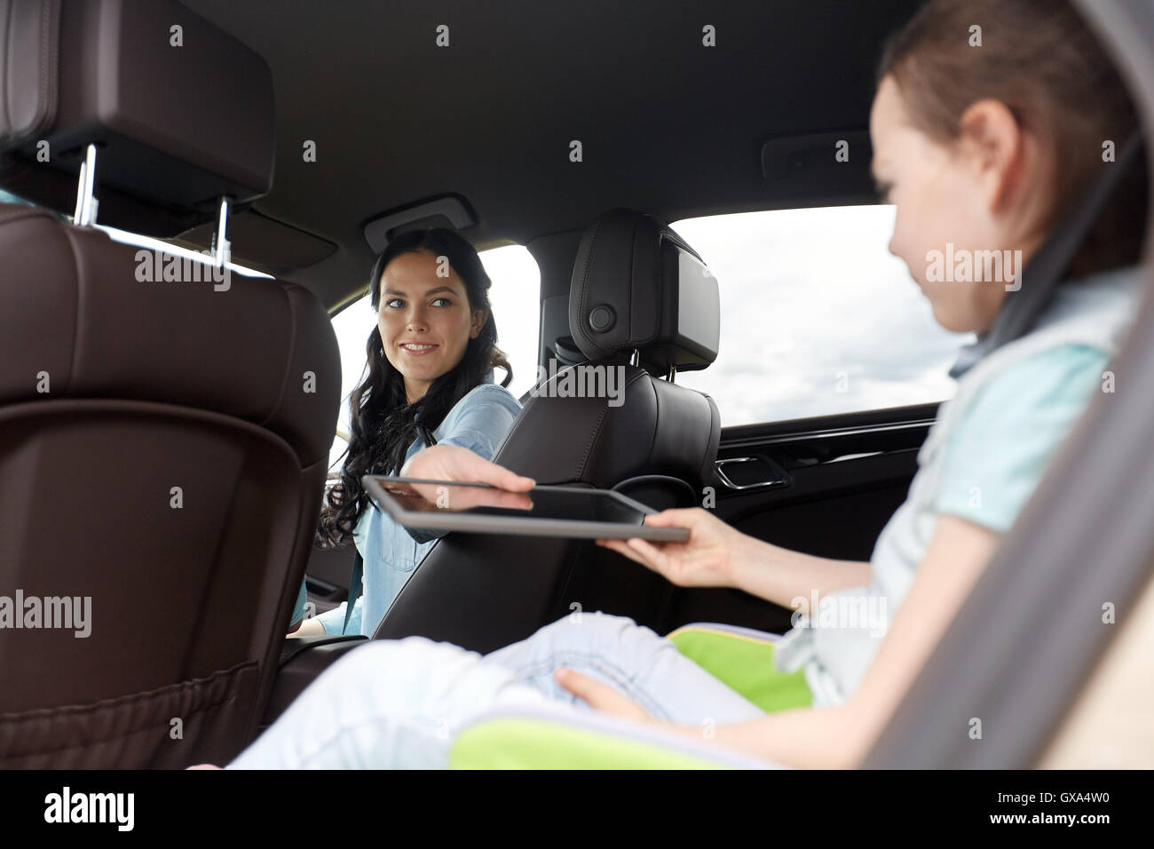 happy family with tablet pc driving in car Stock Photo - Alamy