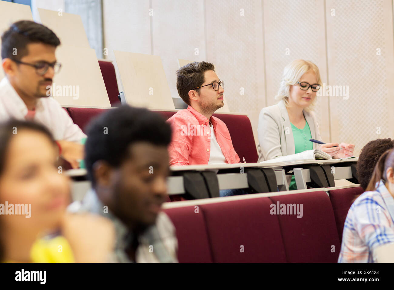 group of students with notebooks in lecture hall Stock Photo - Alamy