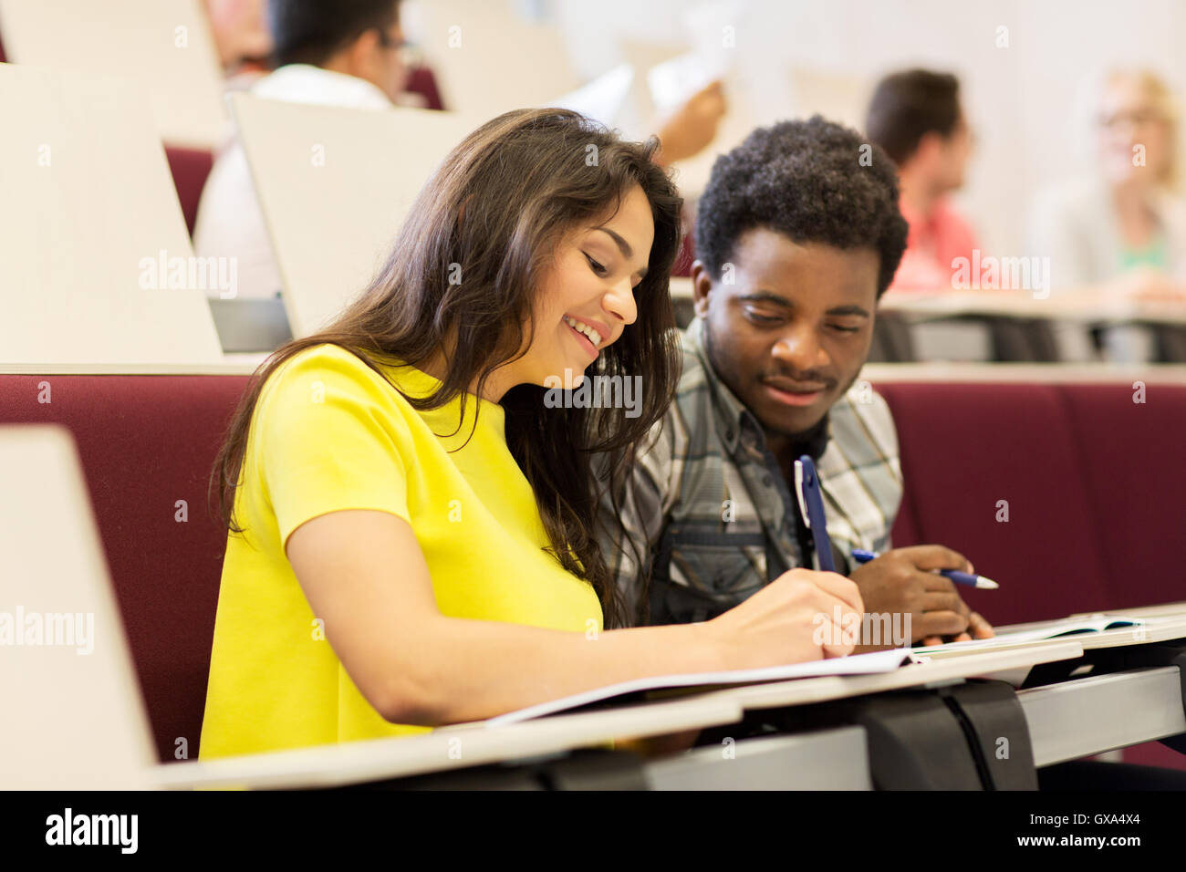 group of students with notebooks in lecture hall Stock Photo - Alamy
